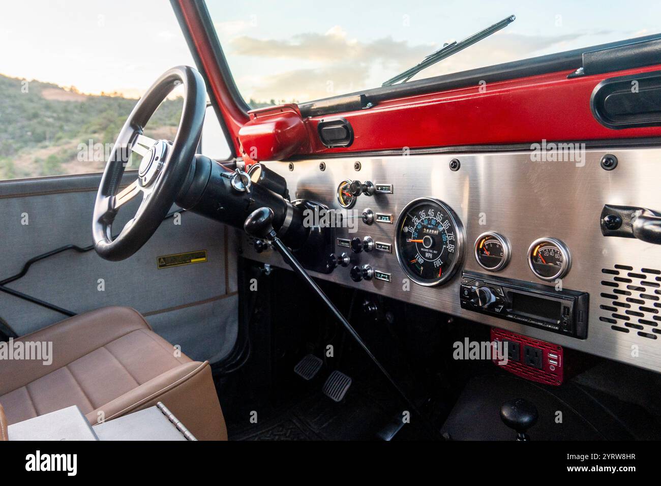 Classic off-road vehicle interior with controls and instruments visible ...