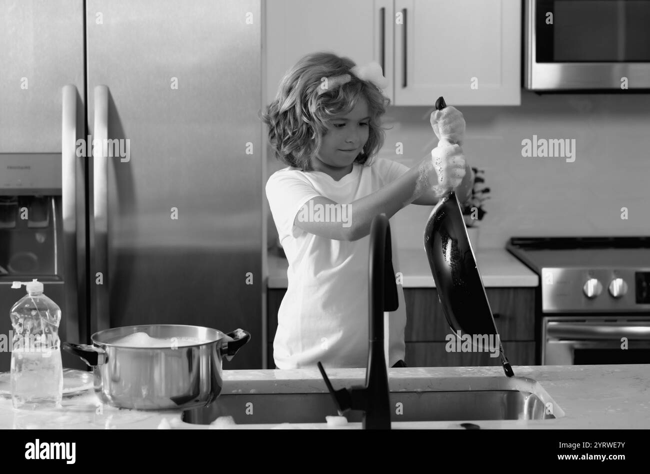 Funny twin boys helping in kitchen with washing dishes. Children having ...