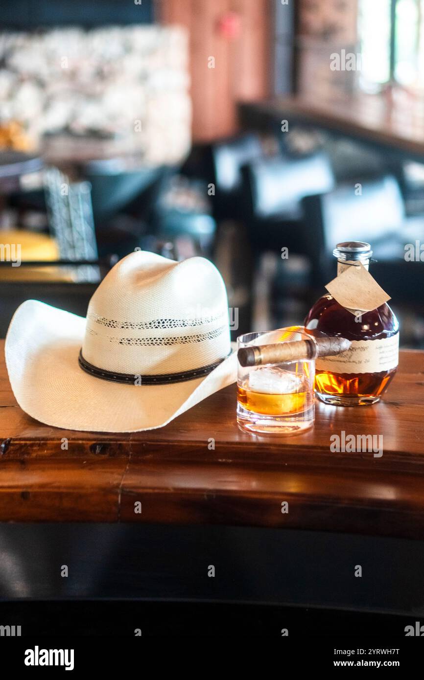 Cowboy hat and whiskey create a rustic atmosphere in a cozy bar Stock ...