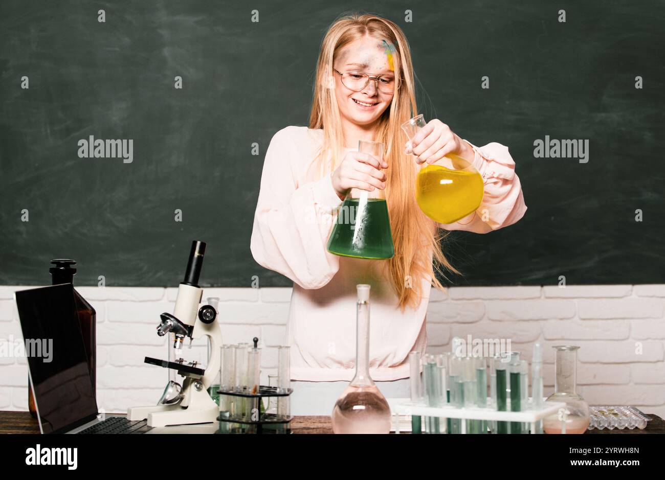 Funny little school child doing experiments in the laboratory. Science ...