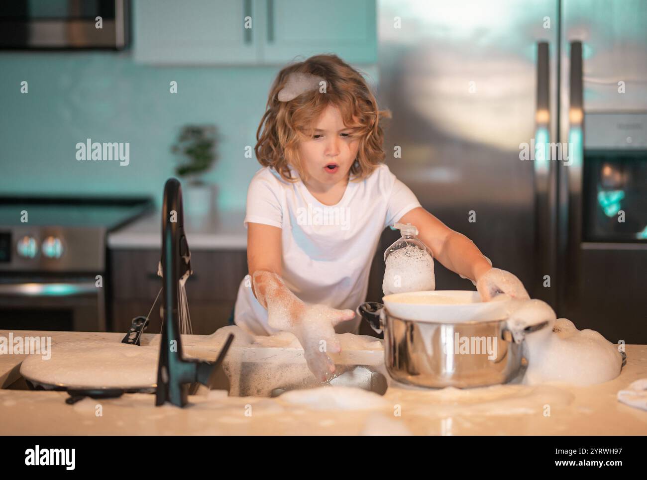 Funny twin boys helping in kitchen with washing dishes. Children having ...