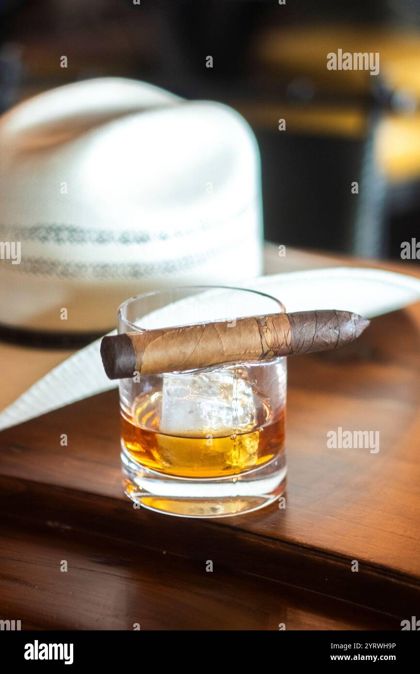 Cowboy hat and whiskey create a rustic atmosphere in a cozy bar Stock ...