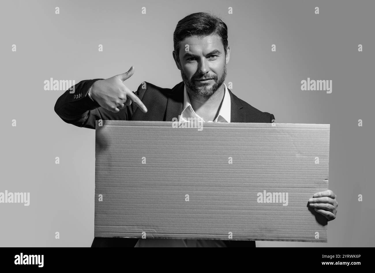 Business man holds sign, blank card. Placard ready for your product ...