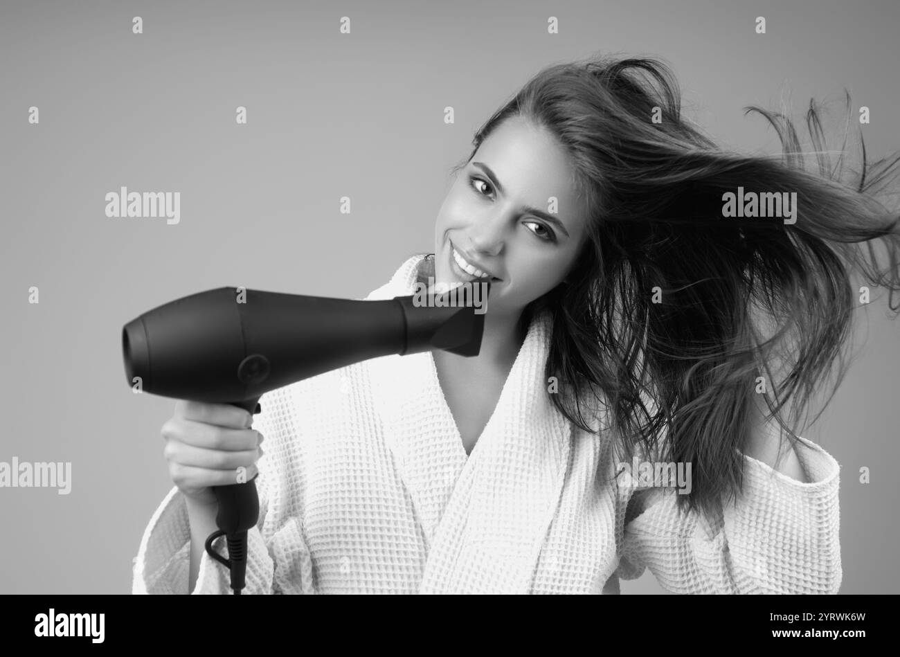 Woman with hair dryer on studio background. Girl hold hairdryer. Young ...