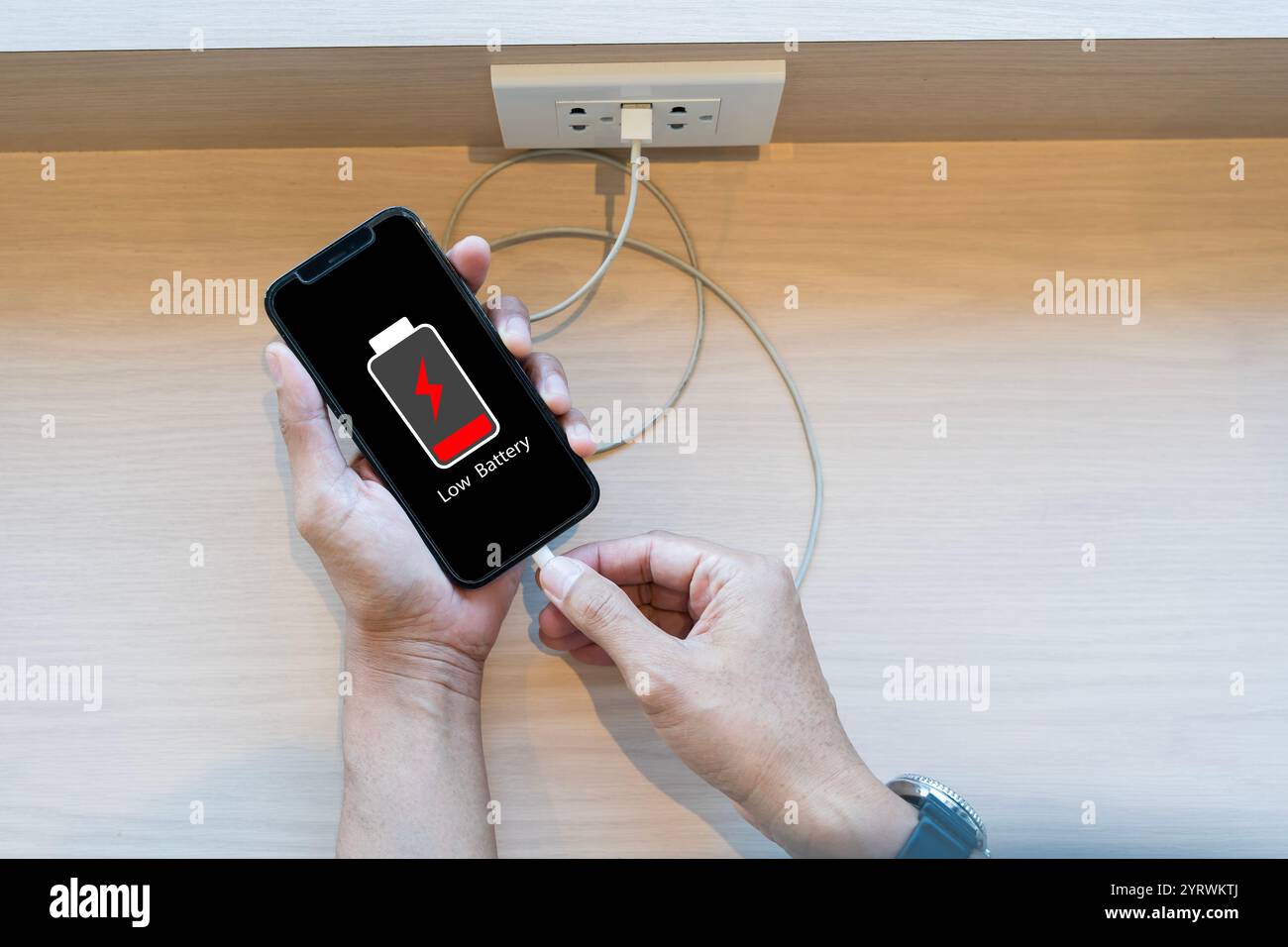 Close up man's hands using smart phone battery low charge battery ...