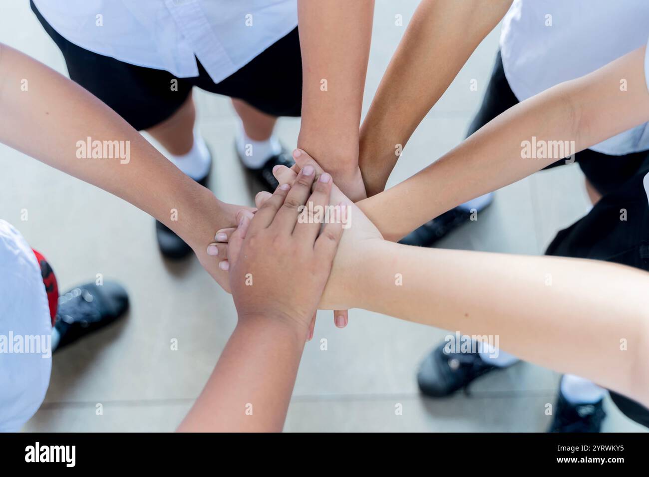 Diverse people join hands in team building. Activity men and women put hands together. Group of ...