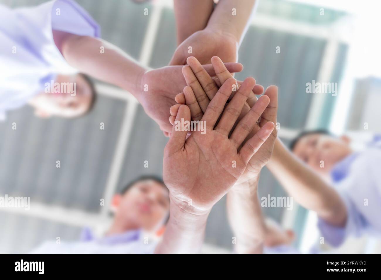Diverse Hands Stacked in Unity and Teamwork. Many children stacking hands together. Symbol for ...