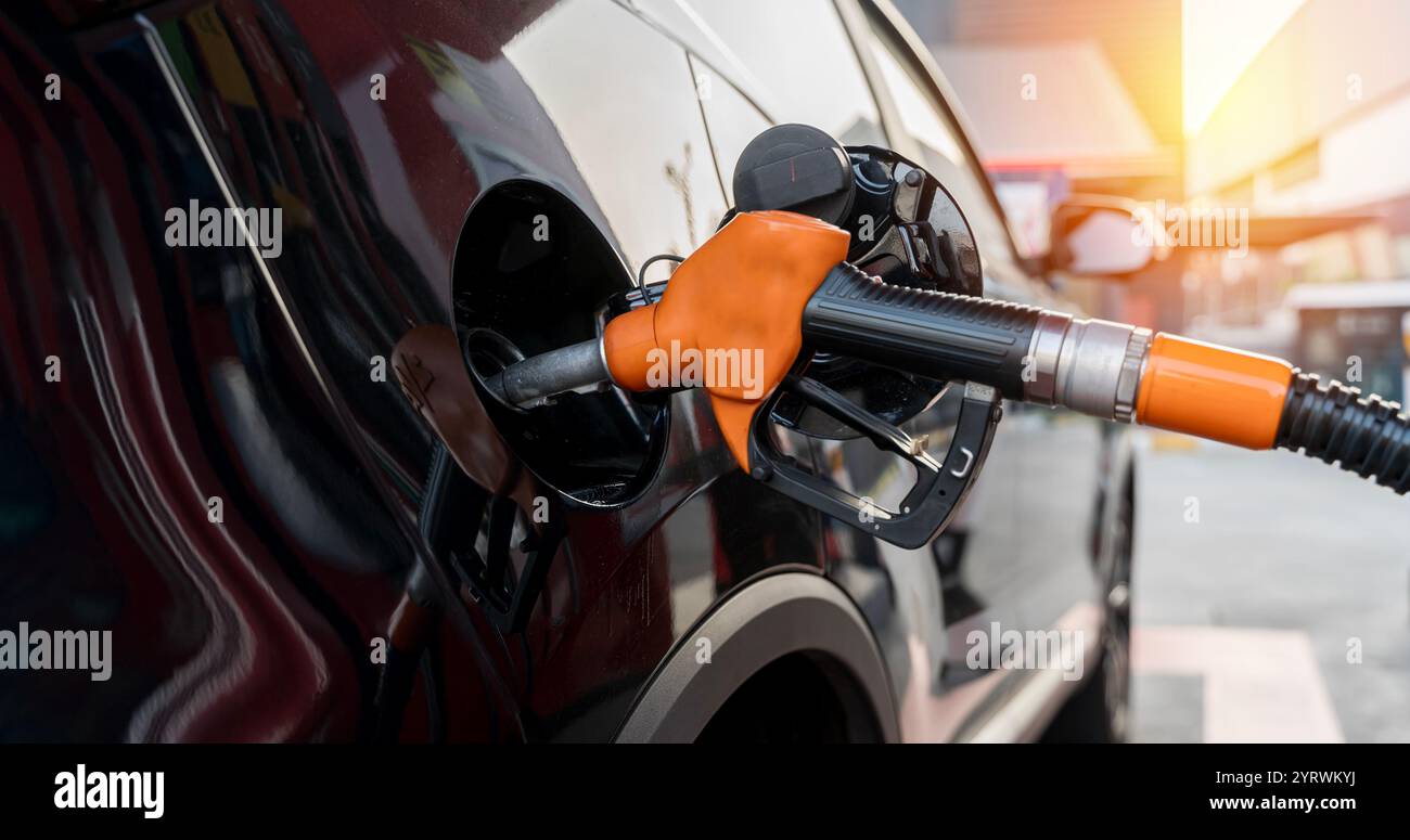 Refueling the car at a gas station fuel pump. Man driver hand refilling ...