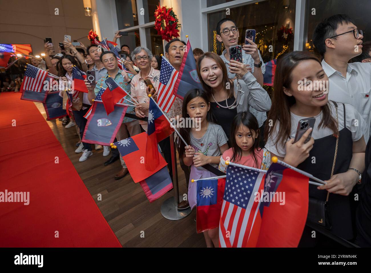 In this photo released by Taiwan Presidential Office, people hold ...