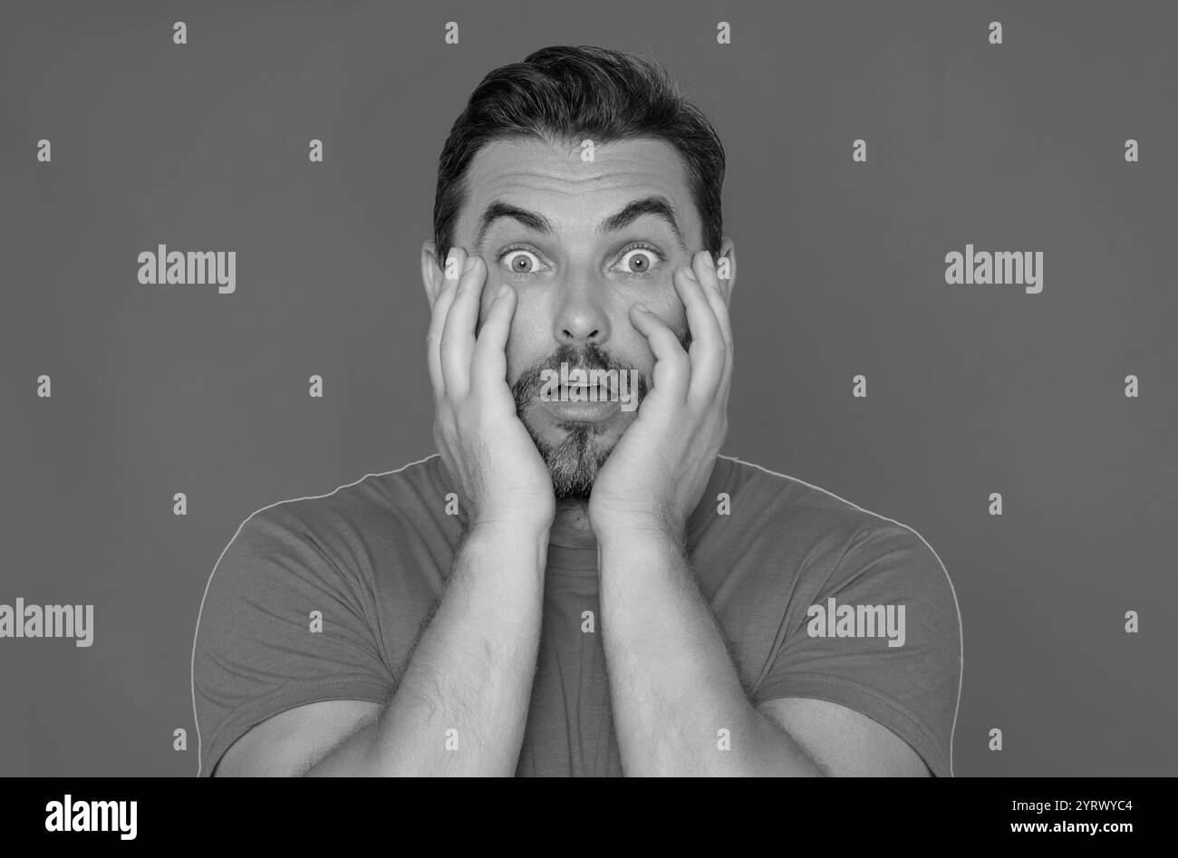 Handsome surprised man over isolated studio background afraid and ...