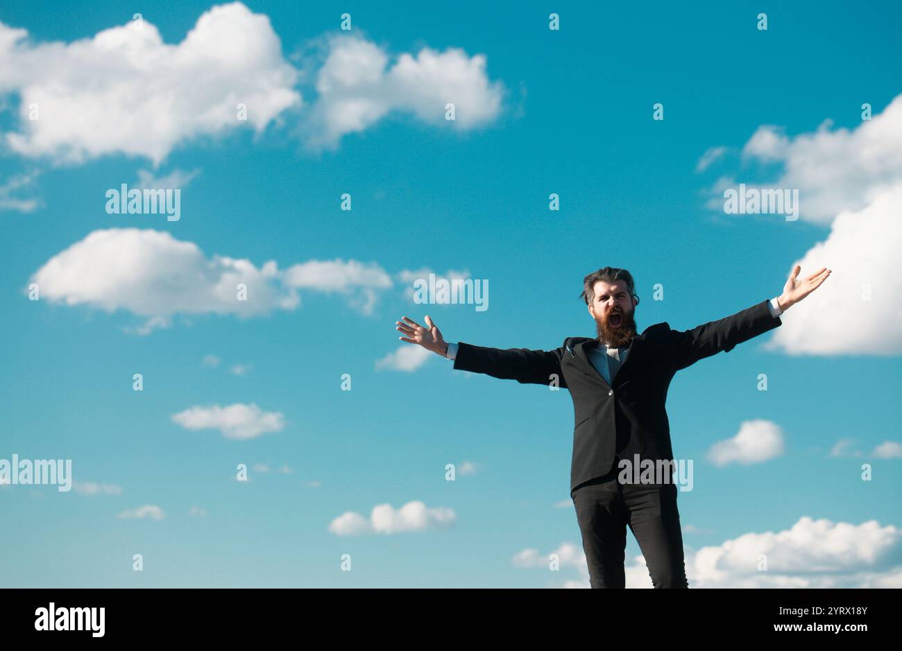Man in suit raising hand on sky background. Freedom adventure and ...