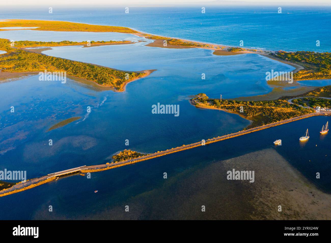 Aerial view a narrow bridge joining narrow coastal islands at ...
