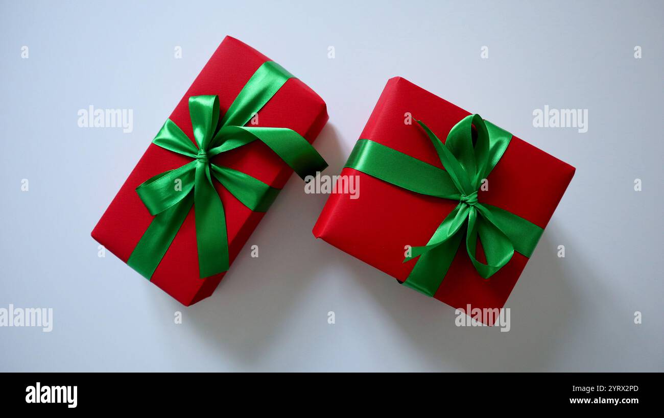 A set of two gifts. Rectangular and square boxes. Red wrapping paper ...