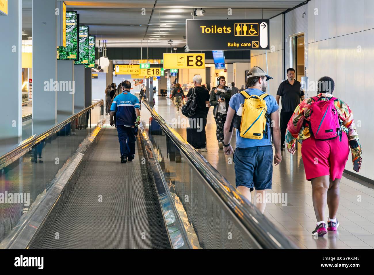 Passengers on moving walkway in terminal building at Schipol ...