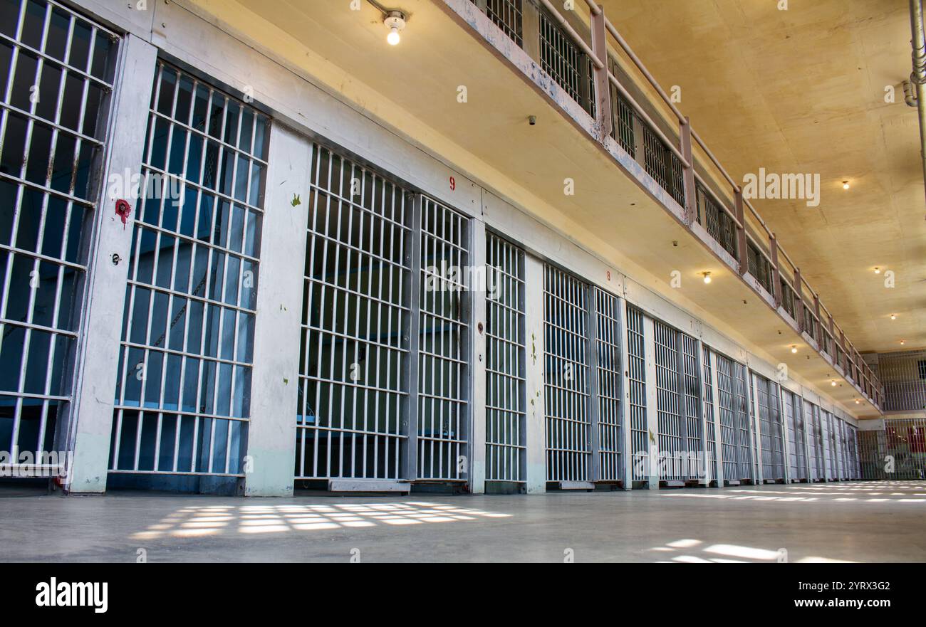 A prison cell block with many cells and bars Stock Photo - Alamy