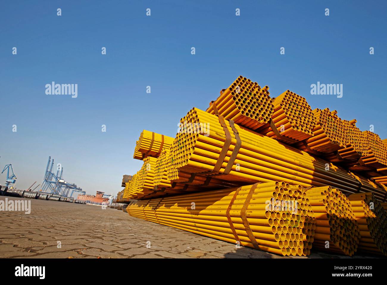 Yellow stacked steel pipe Stock Photo - Alamy