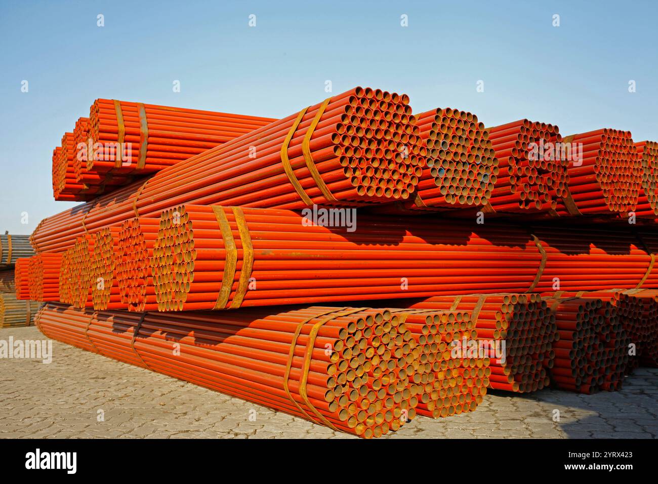 Red stacked steel pipe Stock Photo - Alamy