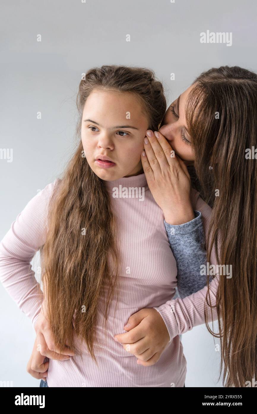 A tender moment between a mother and her teenage daughter with Down ...