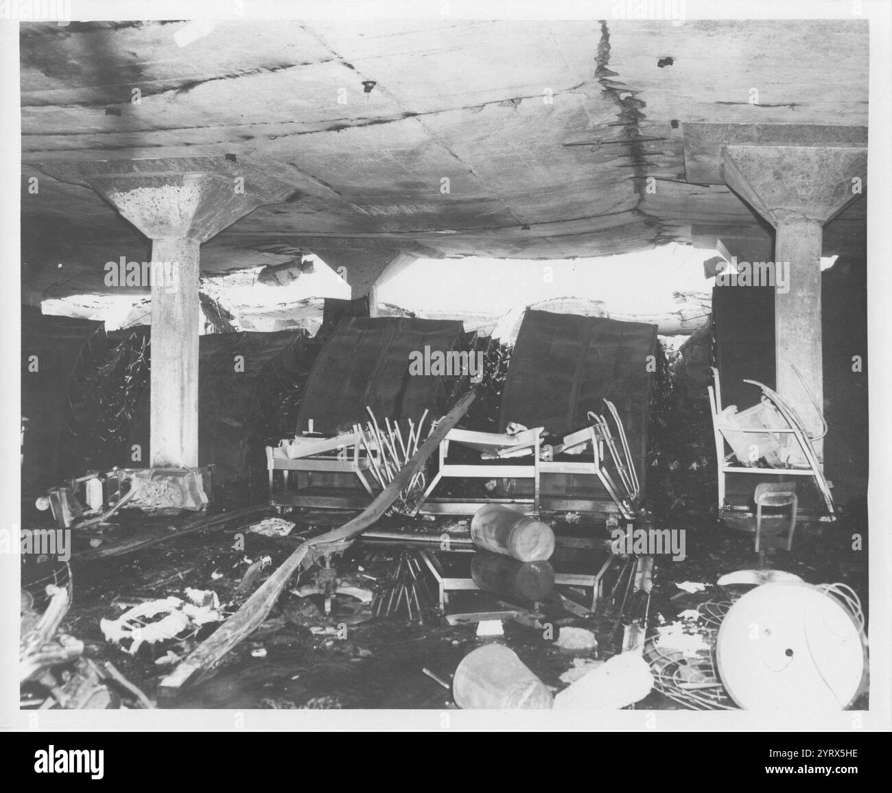 Collapsed shelving and the damaged roof of Building 100 after the 1973 ...
