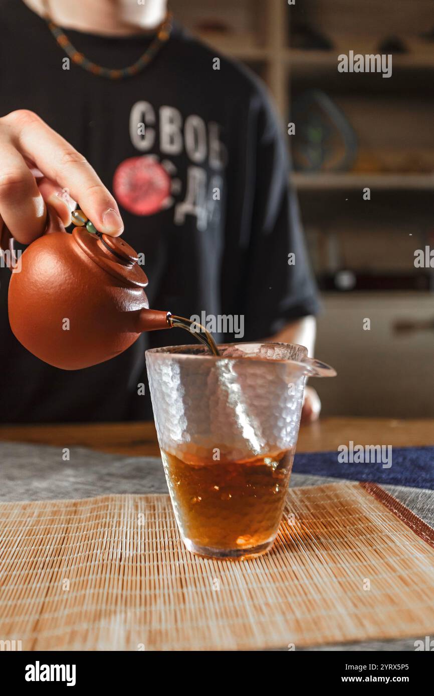 The art of pouring tea from a beautifully crafted traditional teapot ...
