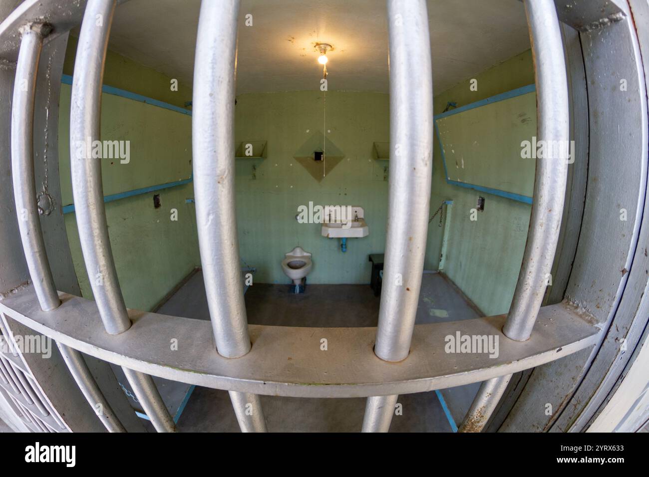 A jail cell with a toilet and sink Stock Photo - Alamy