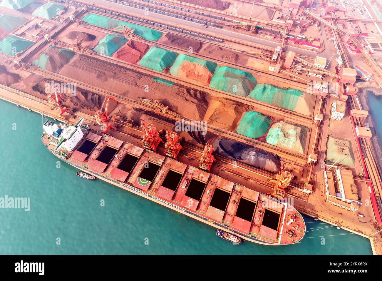QINGDAO, CHINA - DECEMBER 5, 2024 - A cargo ship offloads imported iron ...