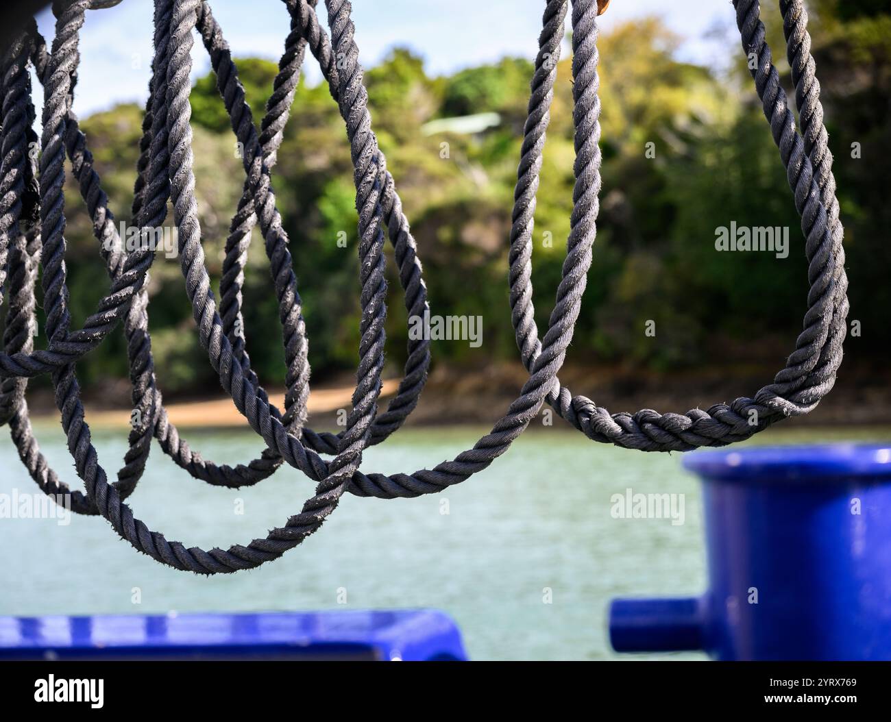 Ropes hanging on a boat approaching the harbour. Russell. Bay of ...