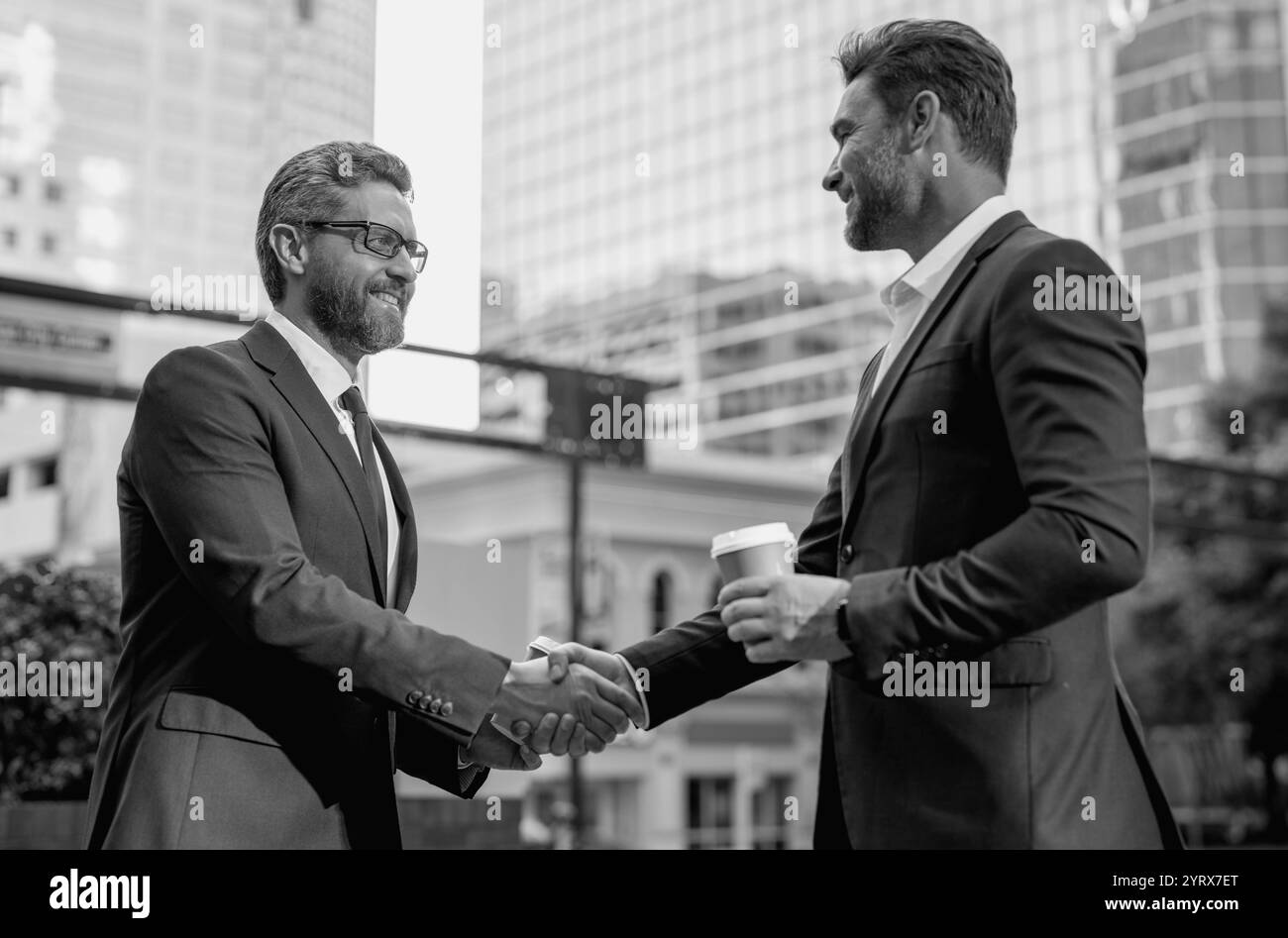 Business partners shaking hands. Two businessmen shaking hands on city ...