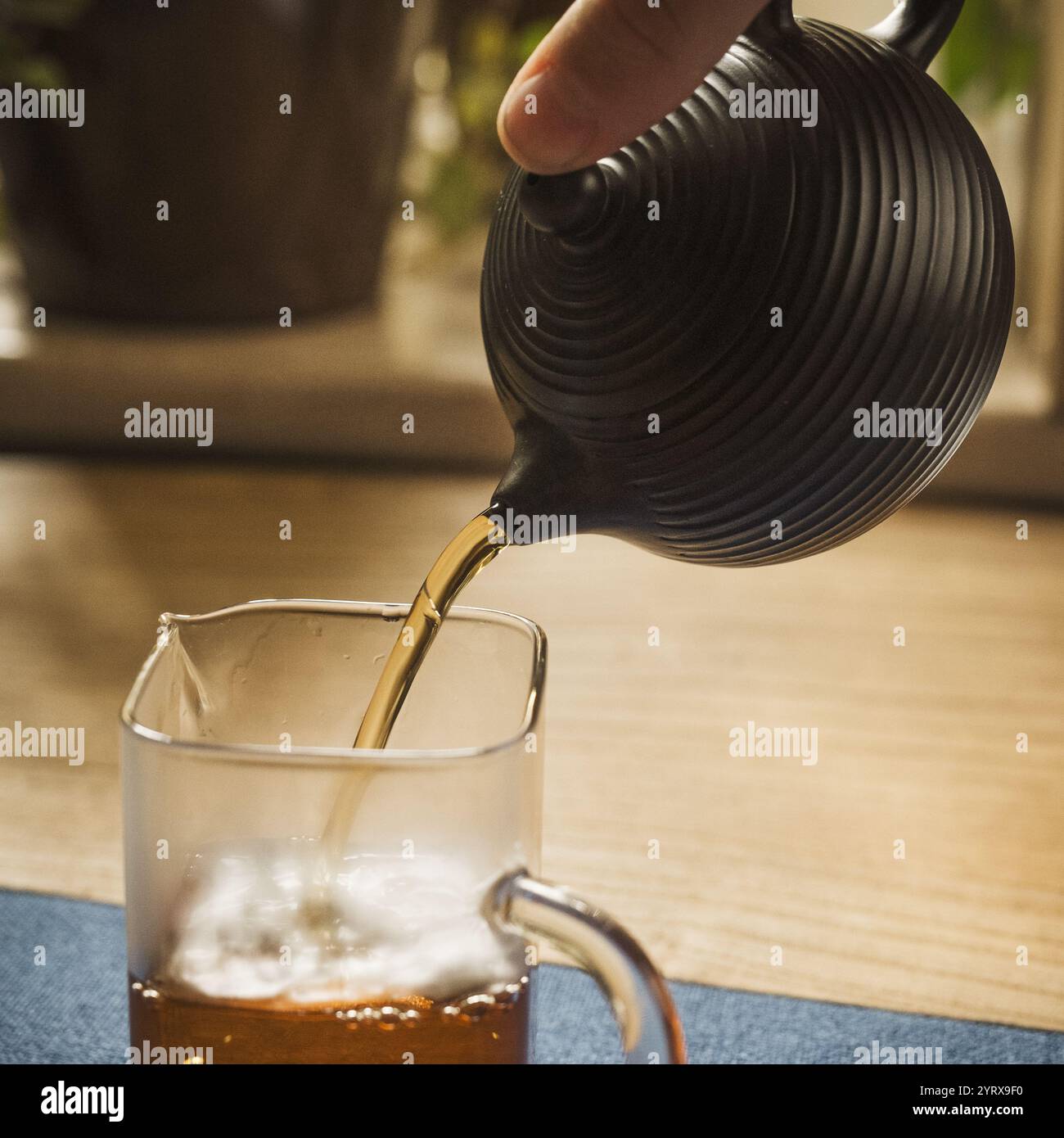 An Elegant and Graceful Process of Tea Pouring, Flowing from a Black ...