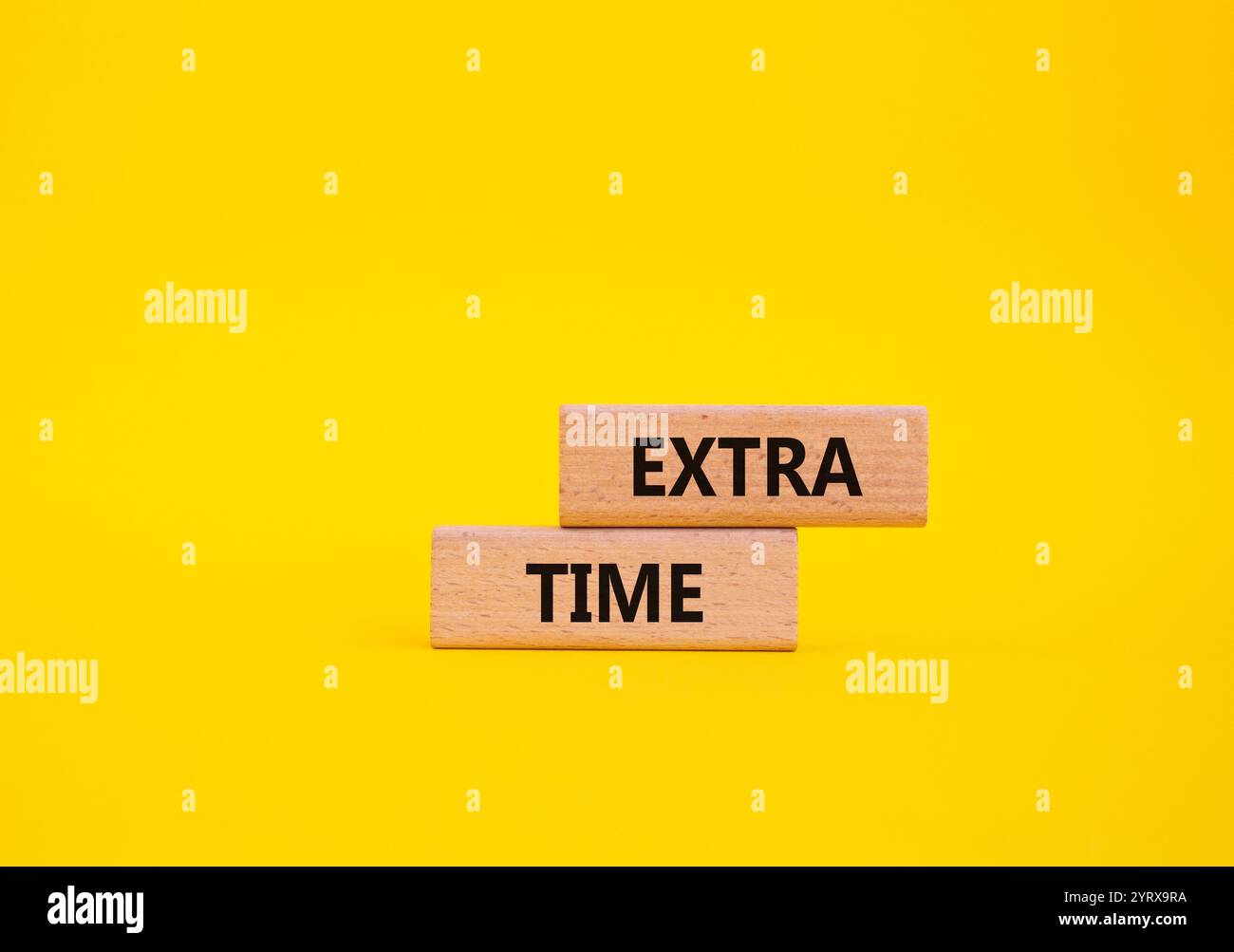 Extra time symbol. Concept word Extra time on wooden blocks. Beautiful ...