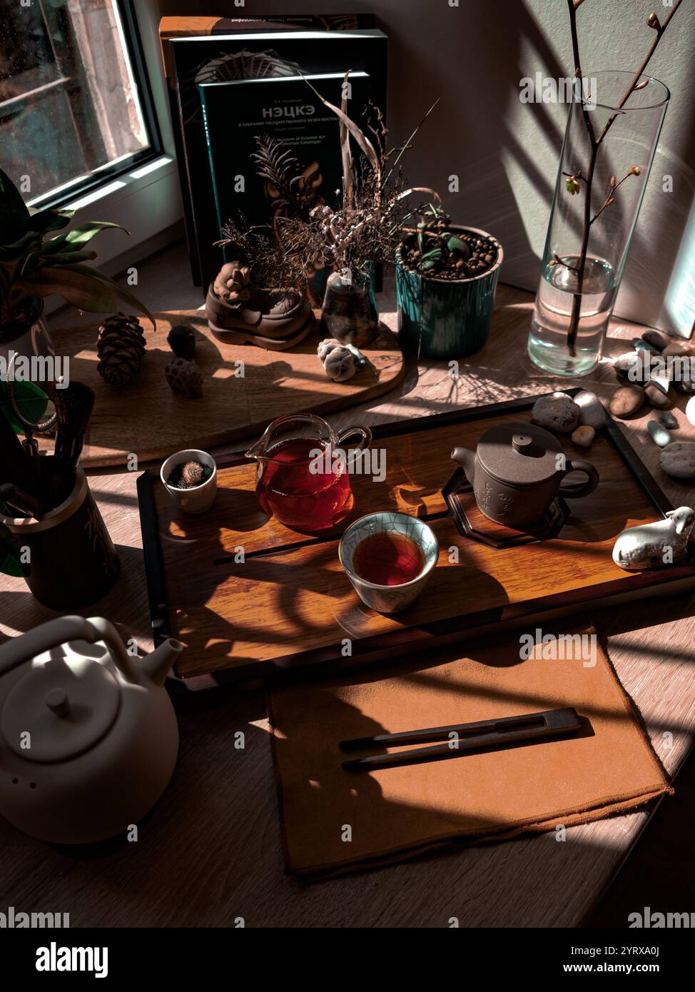 Enjoy a serene tea setup with natural light and botanical accents for a ...