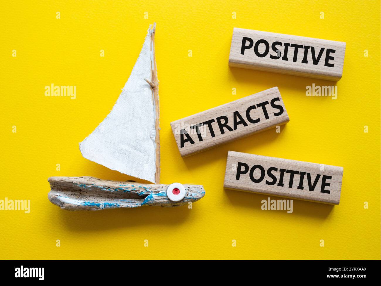 Positive attracts Positive symbol. Wooden blocks with words Positive ...