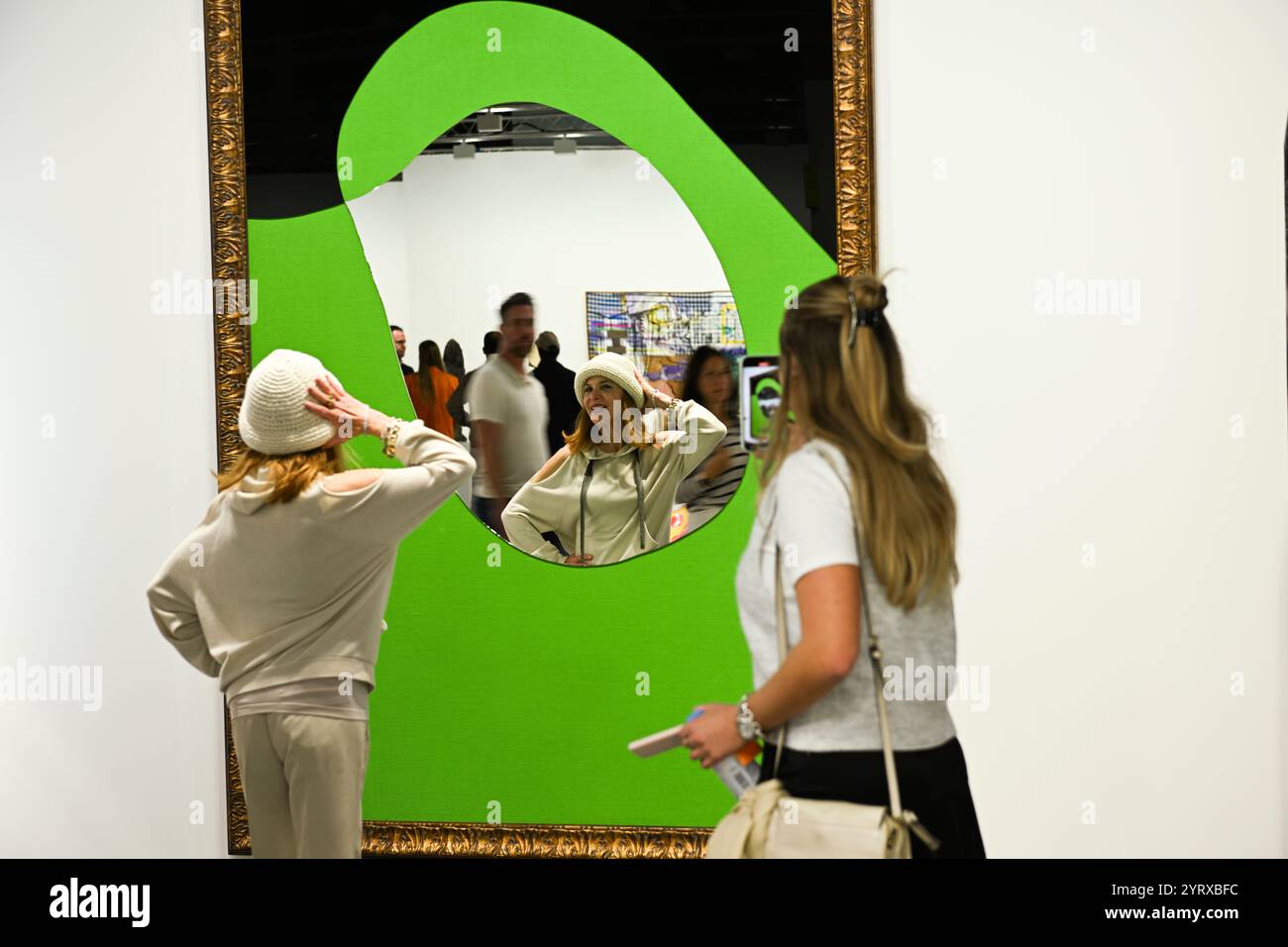 Attendees admire art at the VIP preview day for Art Basel on Wednesday ...
