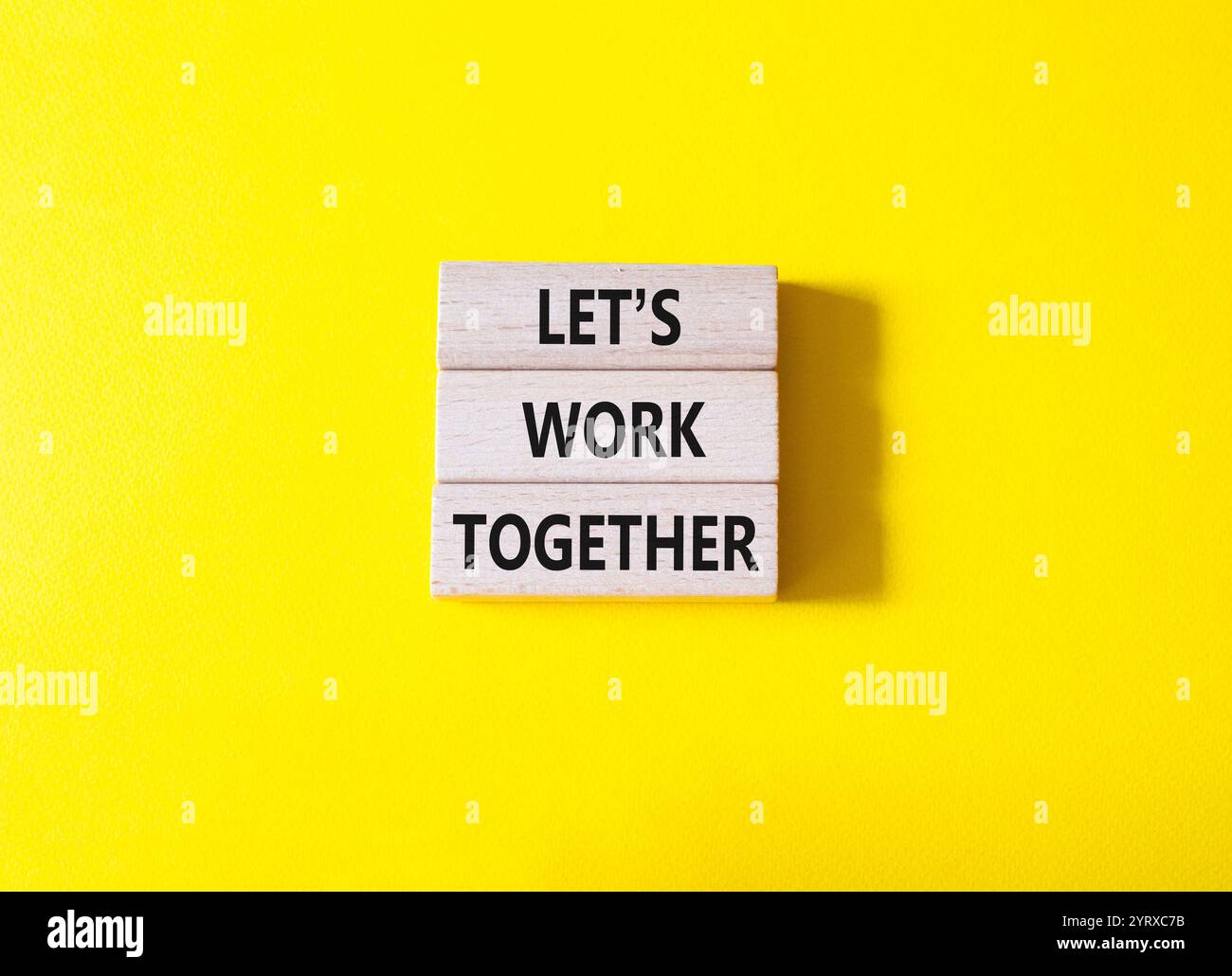 Lets work together symbol. Concept words Less is More on wooden blocks ...
