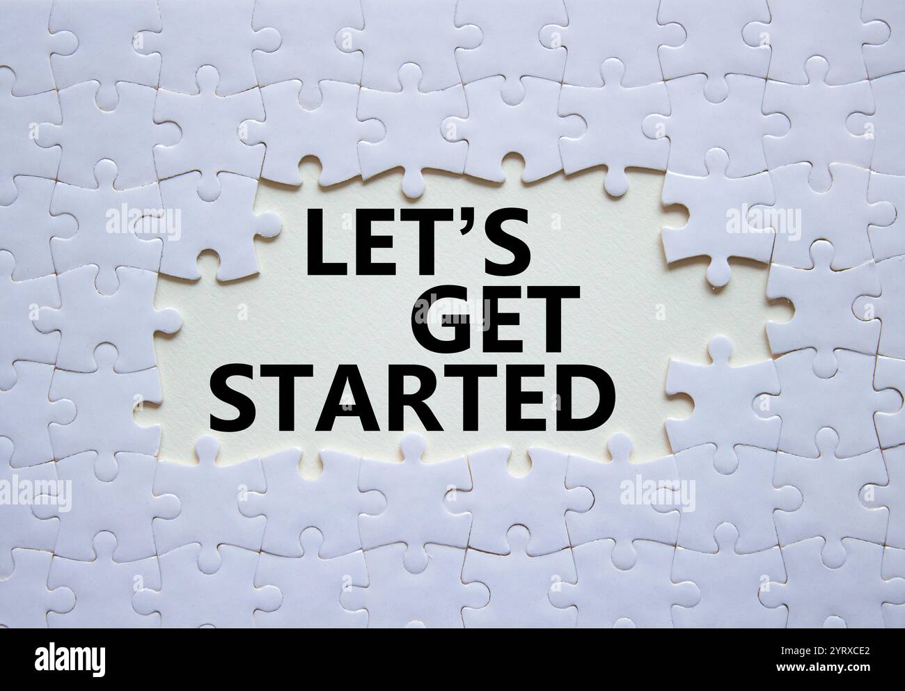 Lets get started symbol. Concept words Lets get started on white puzzle ...