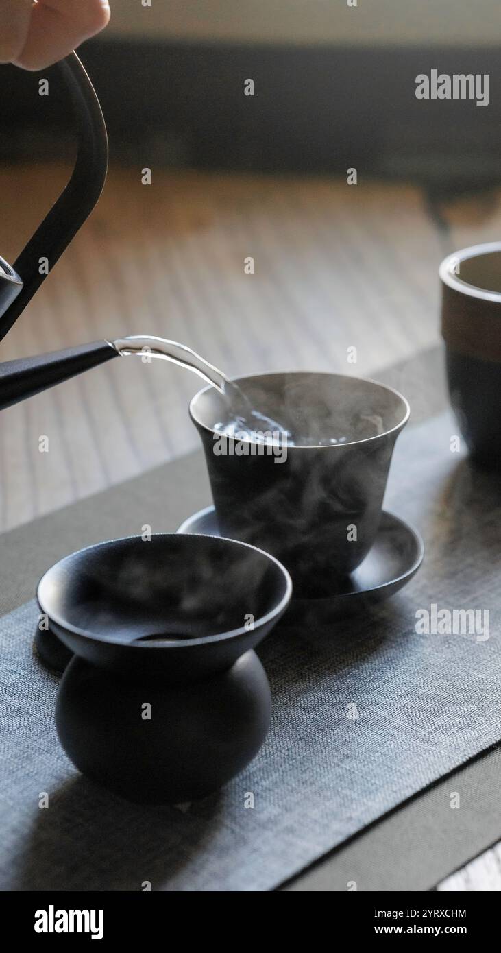 A traditional tea brewing setup showcasing elegant black ceramics for a ...