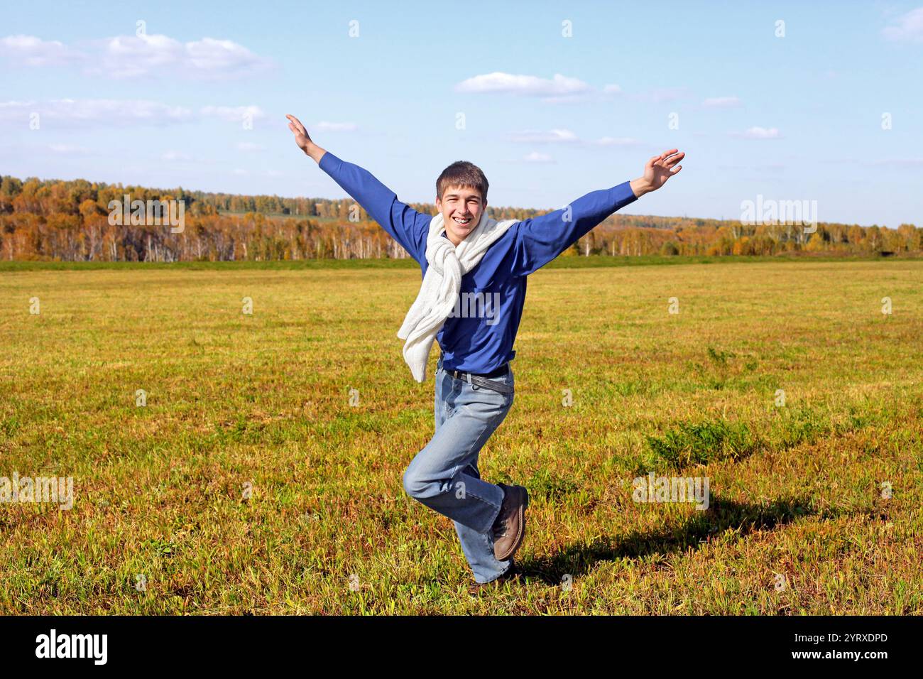 happy teenager running on the autumn field Stock Photo - Alamy