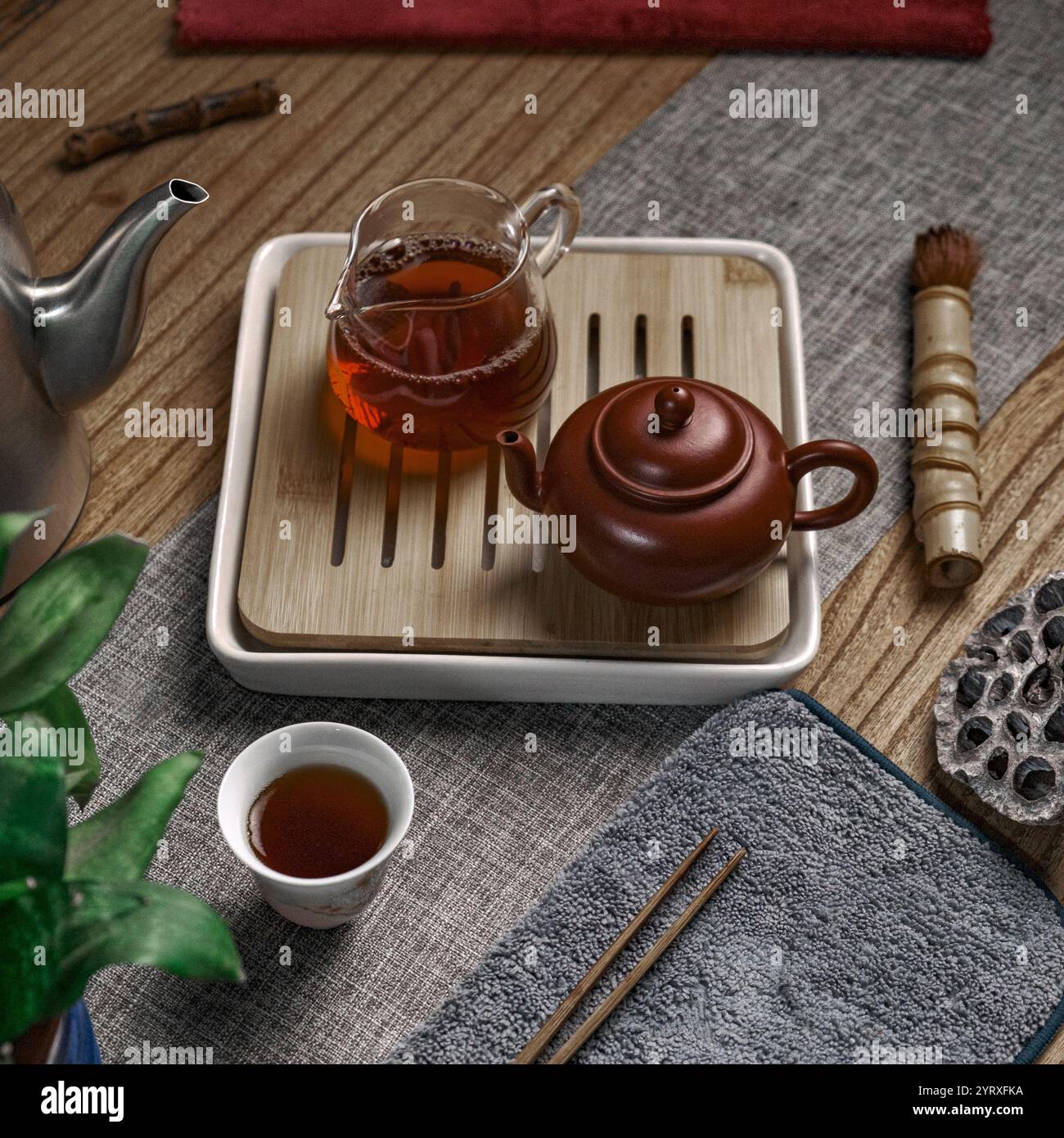 A traditional tea ceremony setup features an elegant teapot accompanied ...