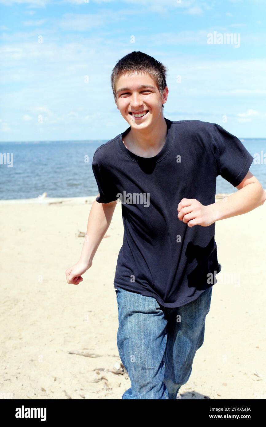 happy teenager running on the beach Stock Photo - Alamy