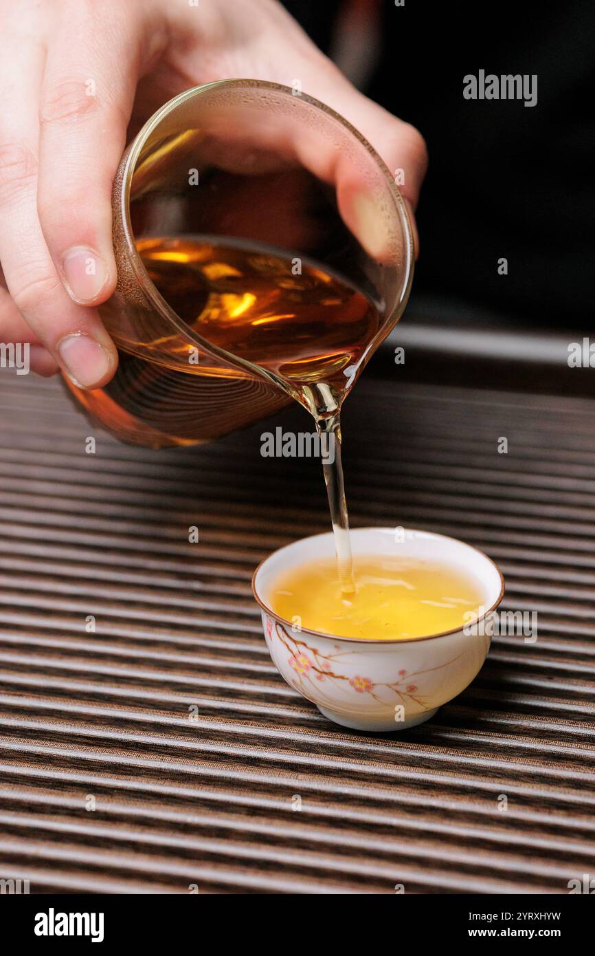 Pouring tea into a traditional cup creates a unique and delightful ...