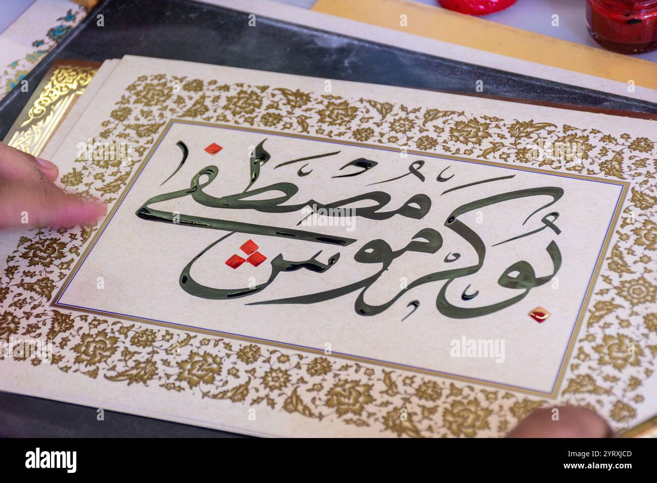 A calligrapher writing a name using a reed pen and ink at the Algiers ...