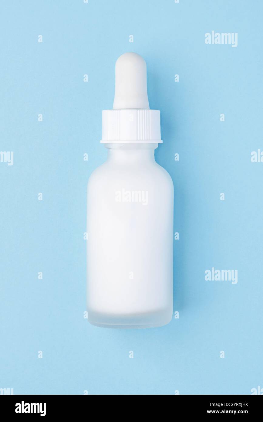 A frosted white dropper bottle with a minimalist design on a pastel ...