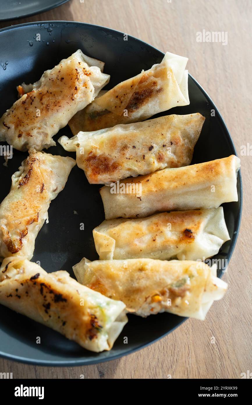 Making spring rolls. Spring roll. It's a traditional Chinese food Stock ...