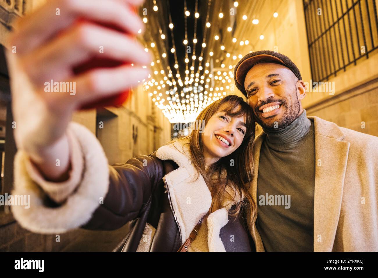 A joyful couple captures a memorable moment with a selfie beneath ...