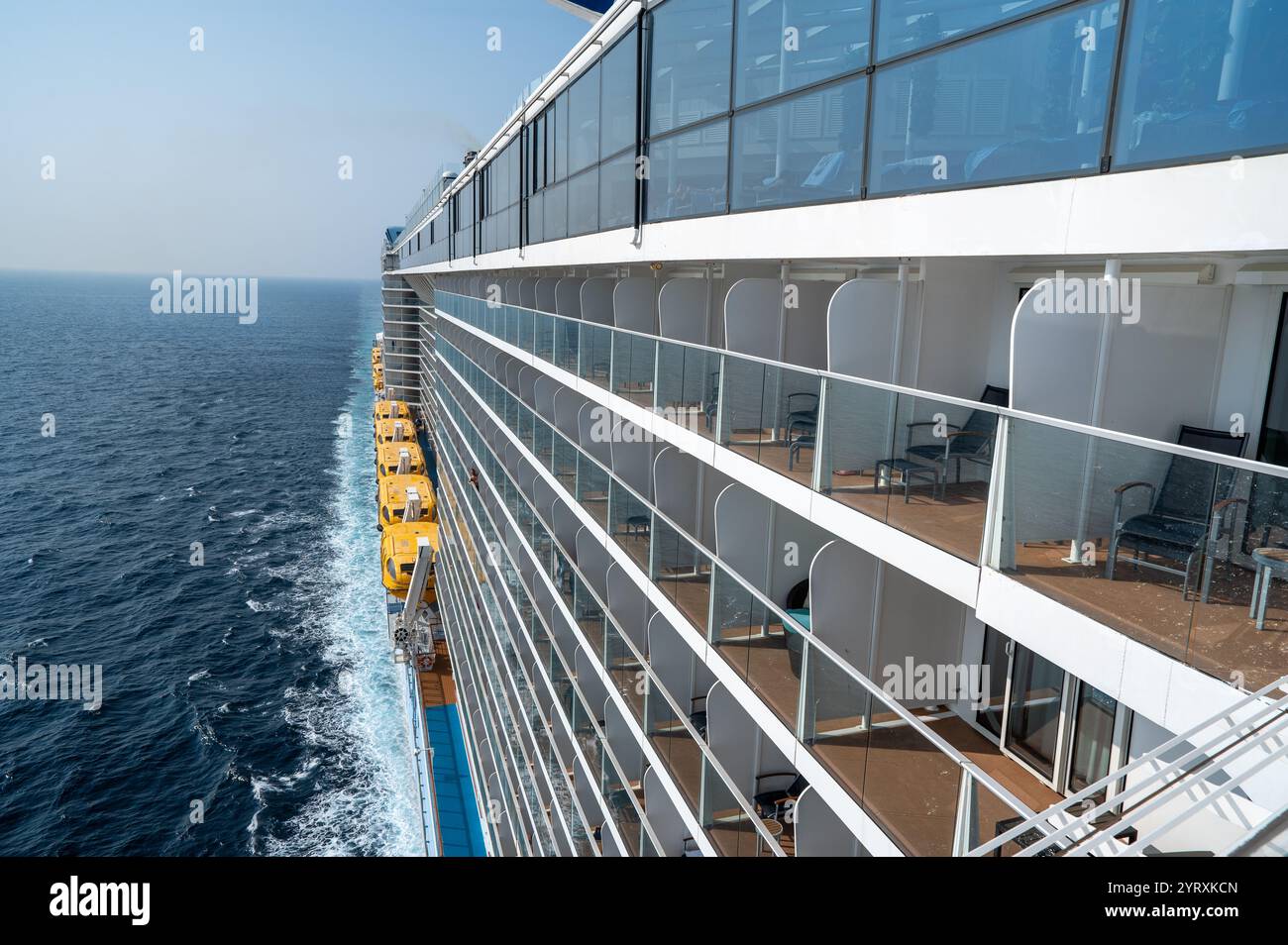 Large cruise liner traveling through calm sea waters, featuring rows of ...