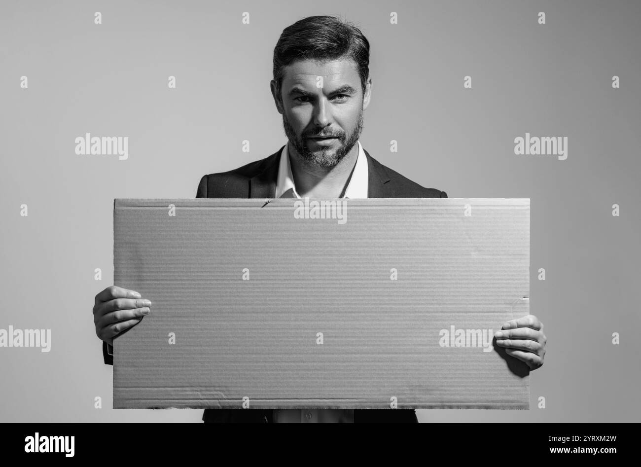 Serious man holds the sign, blank card. Placard ready for your product ...