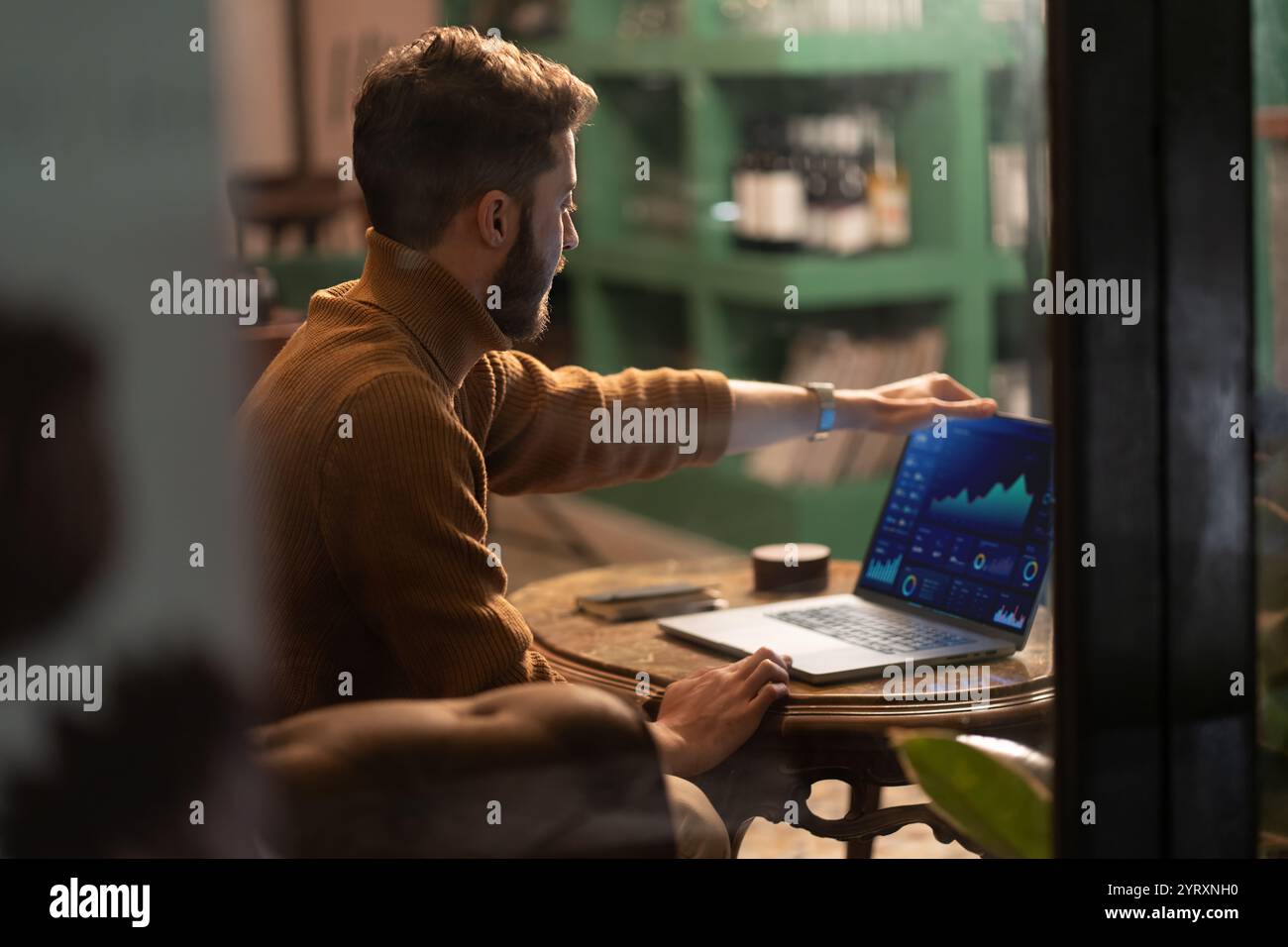 Modern Businessman Reviewing Analytics Dashboard And Performance Metrics On Laptop Professional