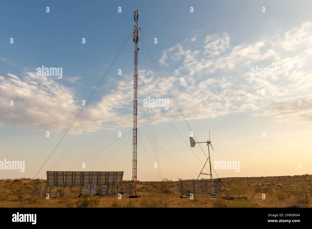 A cell tower stands tall in the desert of Uzbekistan, equipped with ...