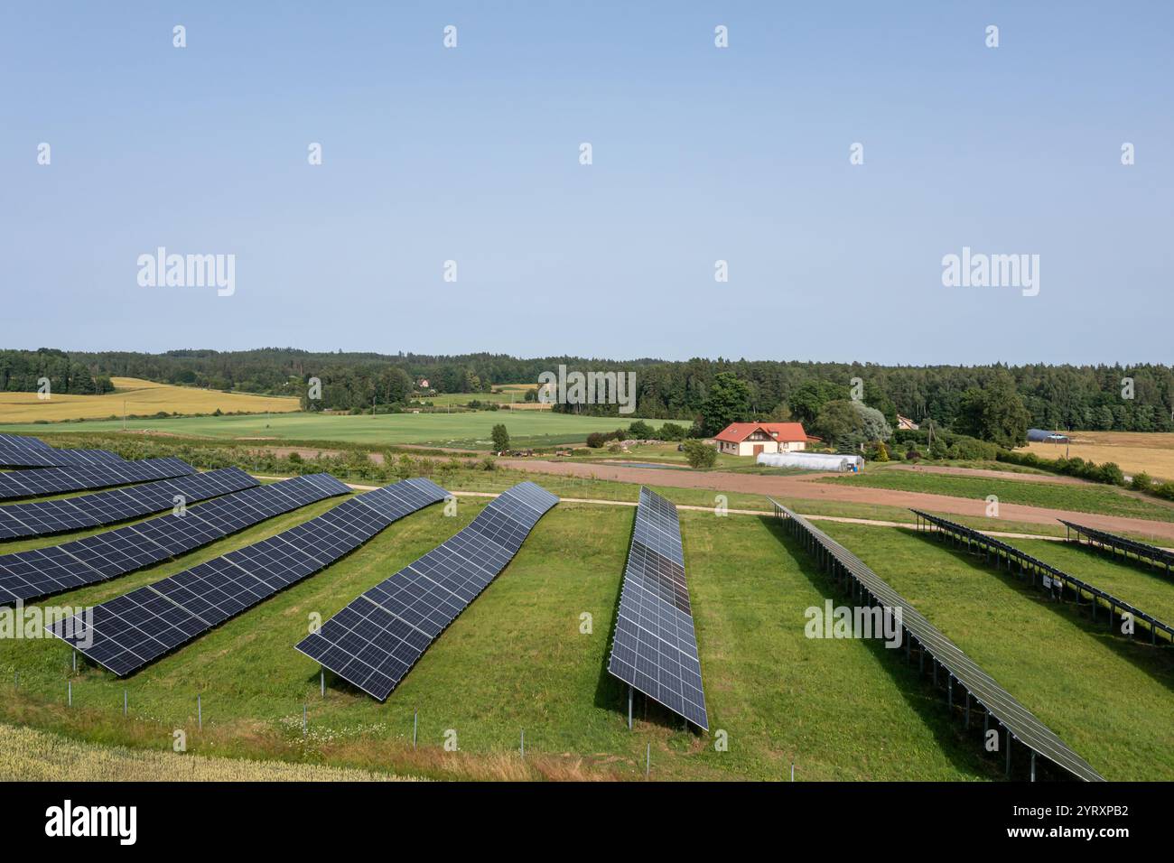 A large solar farm installed on a grassy hillside Stock Photo - Alamy