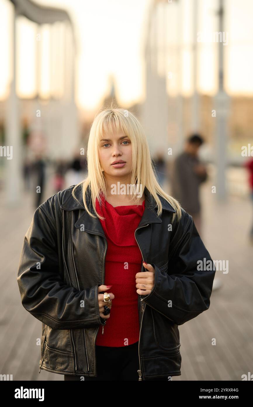 Fashion model posing on city bridge during photoshoot Stock Photo - Alamy